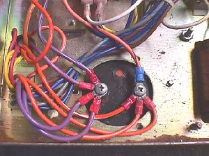 Flip it over & replace the wires on the cap terminals & tighten them ...